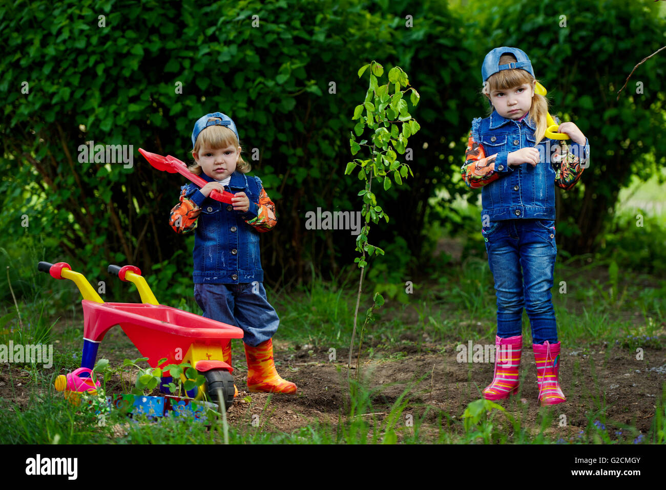 happy girls planting tree Stock Photo - Alamy