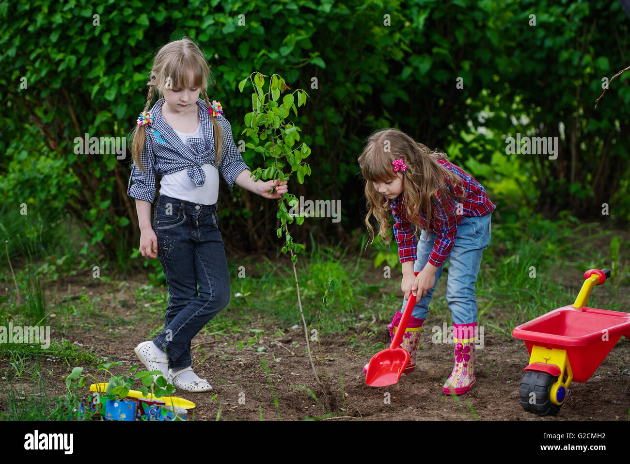 happy girls planting tree Stock Photo - Alamy