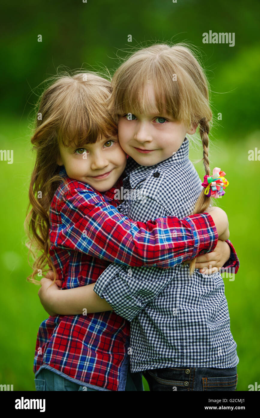 photo of two happy hugging girls Stock Photo - Alamy