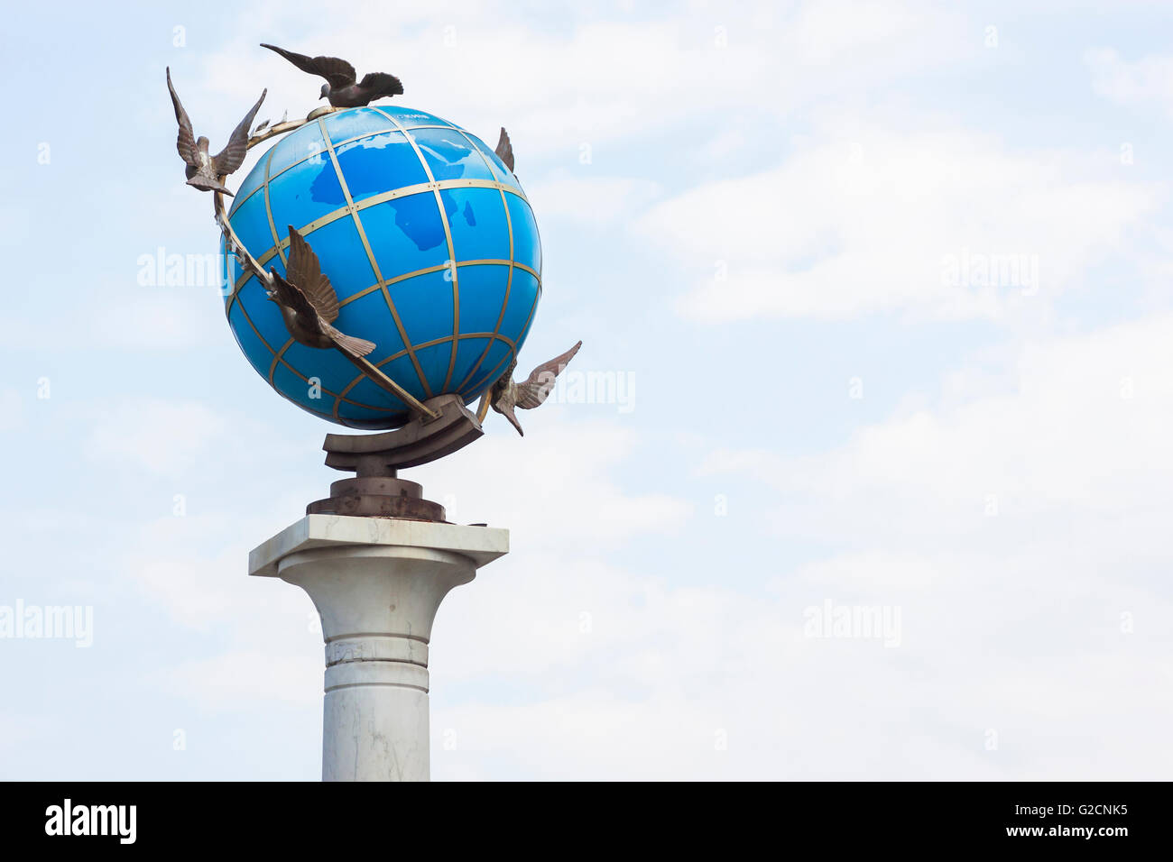 Earth globe with doves around it Stock Photo - Alamy