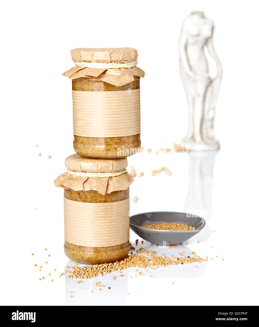 Studio shot of mustard. Two jars of mustard and the antique sculpture ...