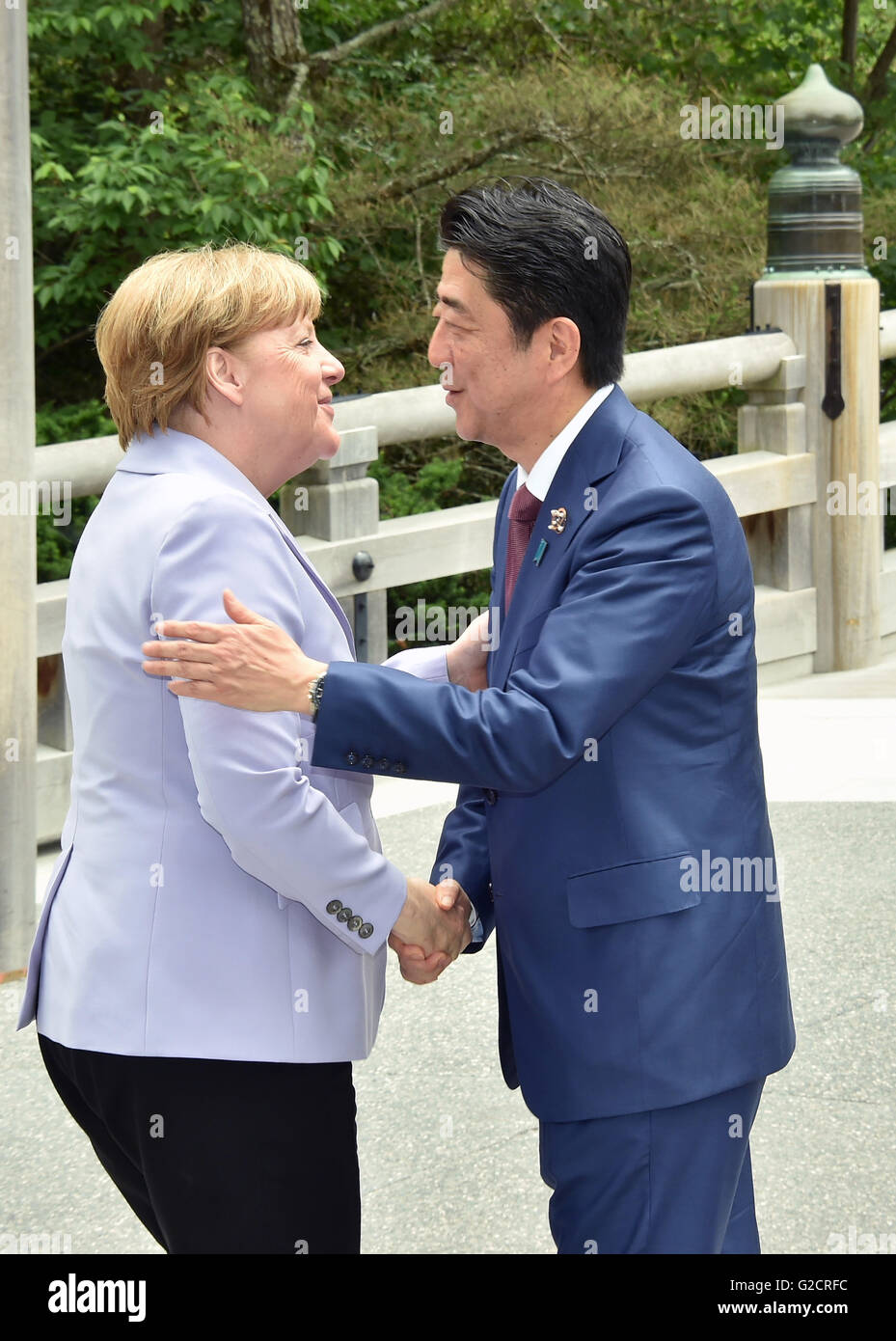 Japanese Prime Minister Shinzo Abe greets German Chancellor Angela ...