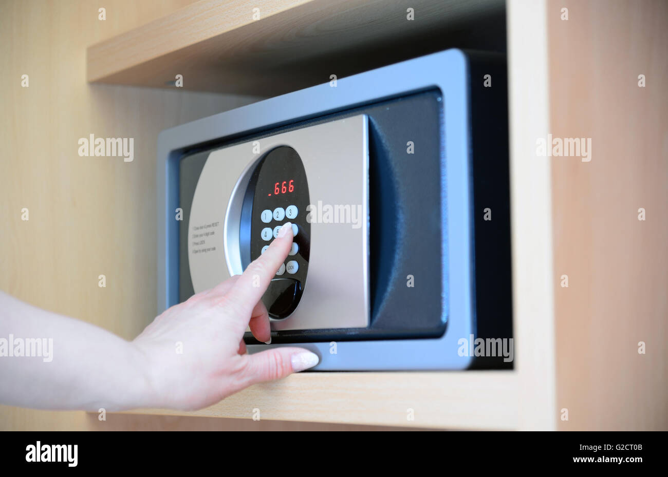 woman uses a safe in hotel Stock Photo - Alamy