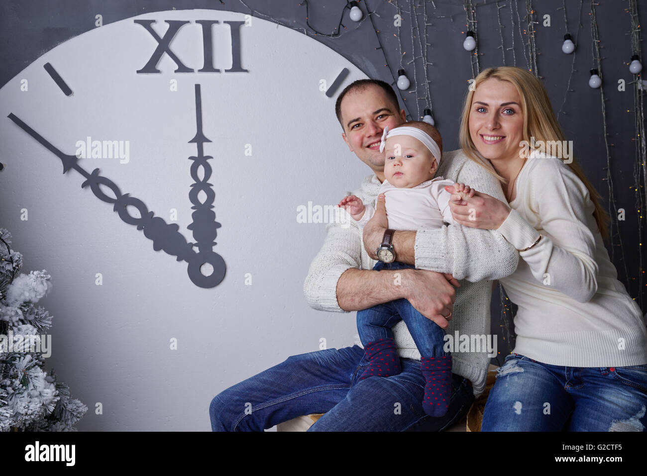 family with big watch on background Stock Photo - Alamy