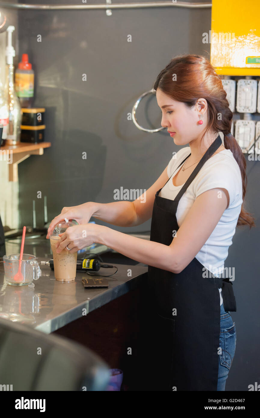 asia beautiful female bartender makes iced coffee on cafe Stock Photo ...