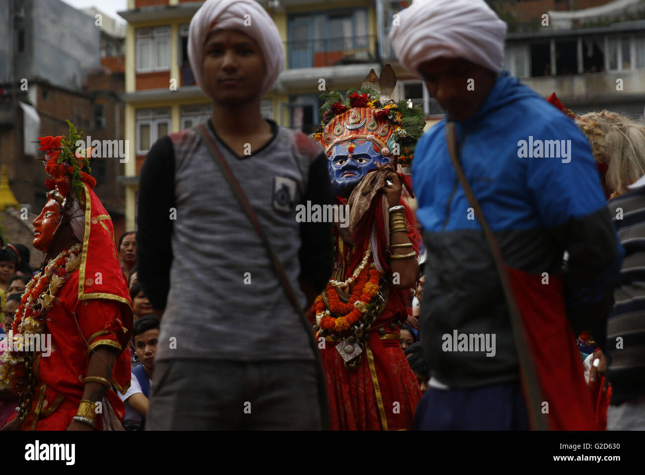 Kathmandu, Nepal. 28th May, 2016. A person dressed as a deity arranges ...