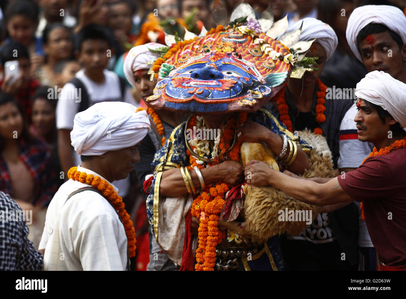 Kathmandu, Nepal. 28th May, 2016. A person dressed as deity carries a ...