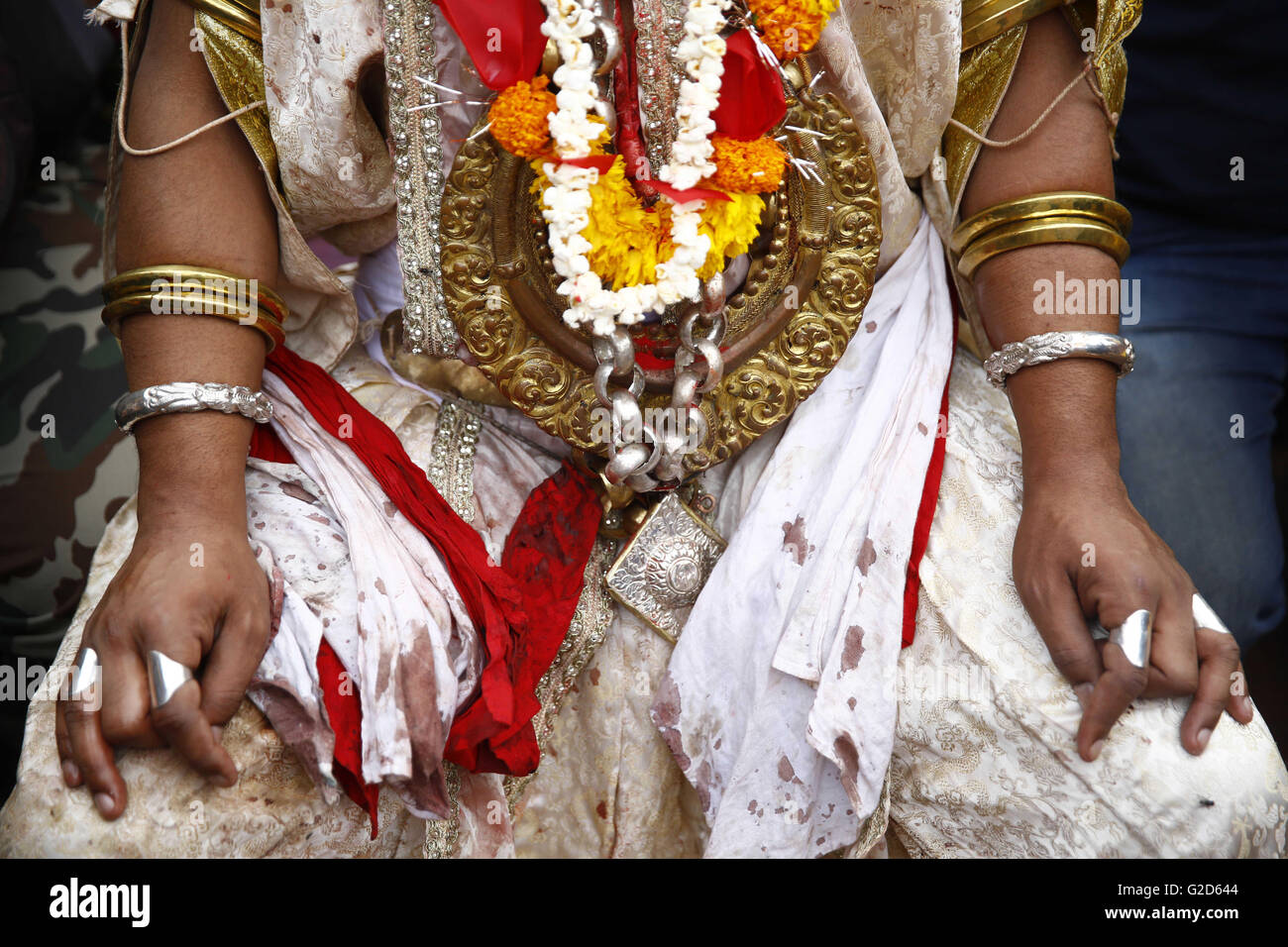 Kathmandu, Nepal. 28th May, 2016. A person dressed as s deity sits ...