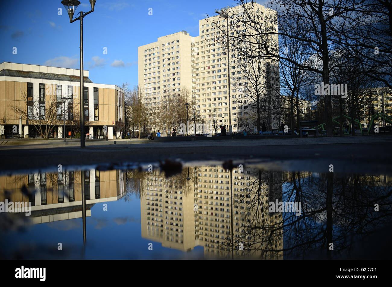 Typical East German buildings reflected in a puddle in Berlin-Marzahn ...