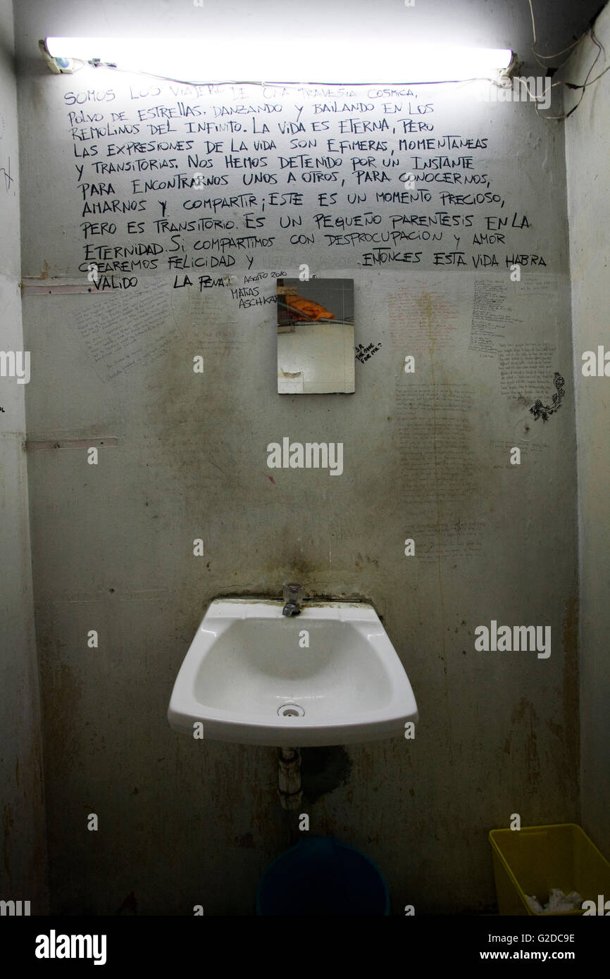 Rundown Bathroom With Sink and Writing on Wall Stock Photo - Alamy