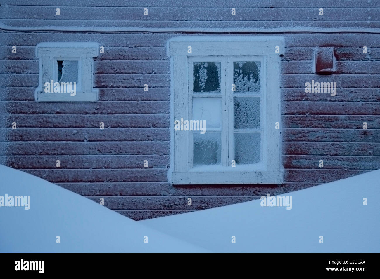 Windows of Red House Covered in Snow and Ice Stock Photo - Alamy
