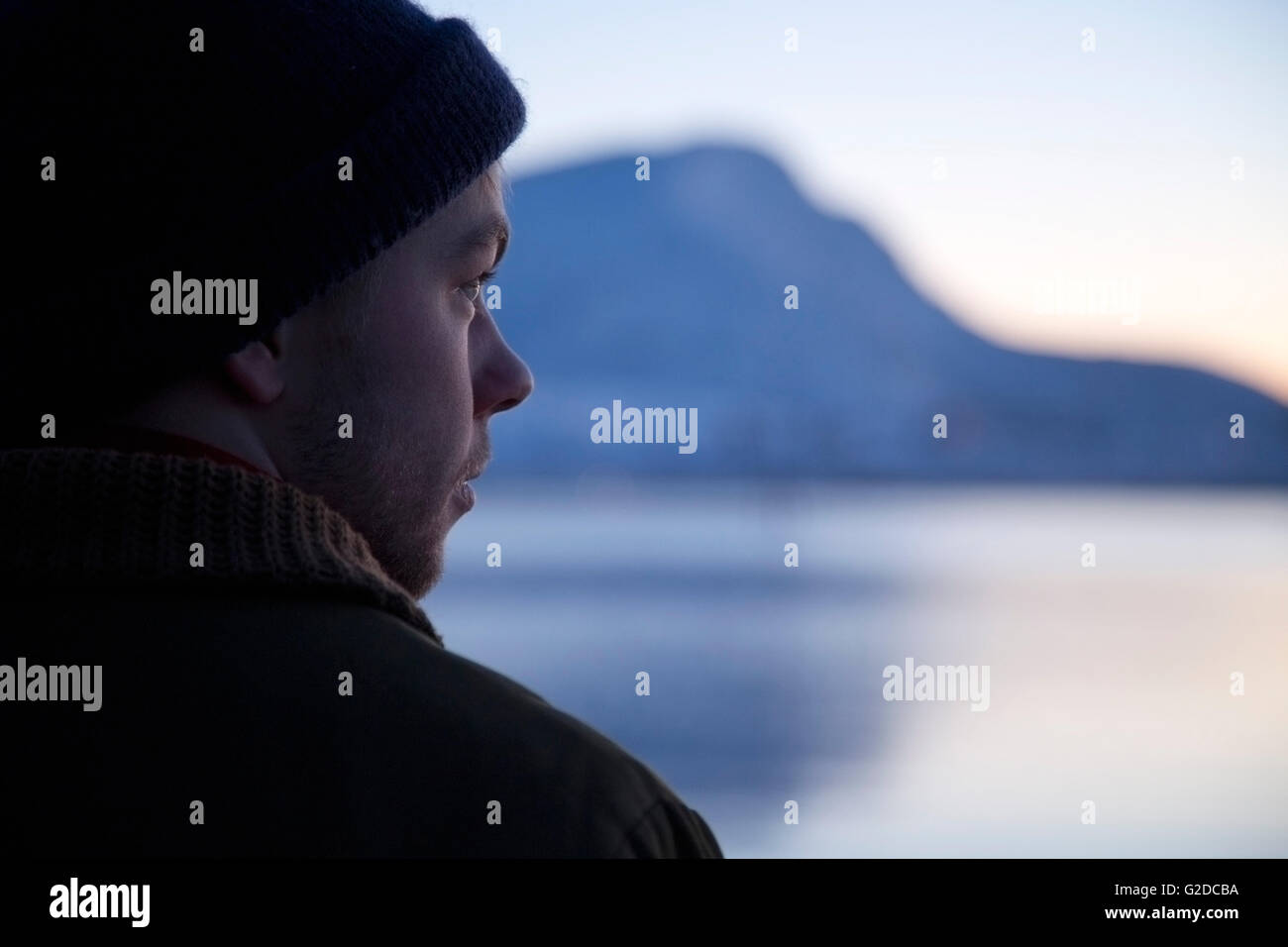 Young Man Gazing at Winter Landscape at Dusk, Rear View Stock Photo - Alamy