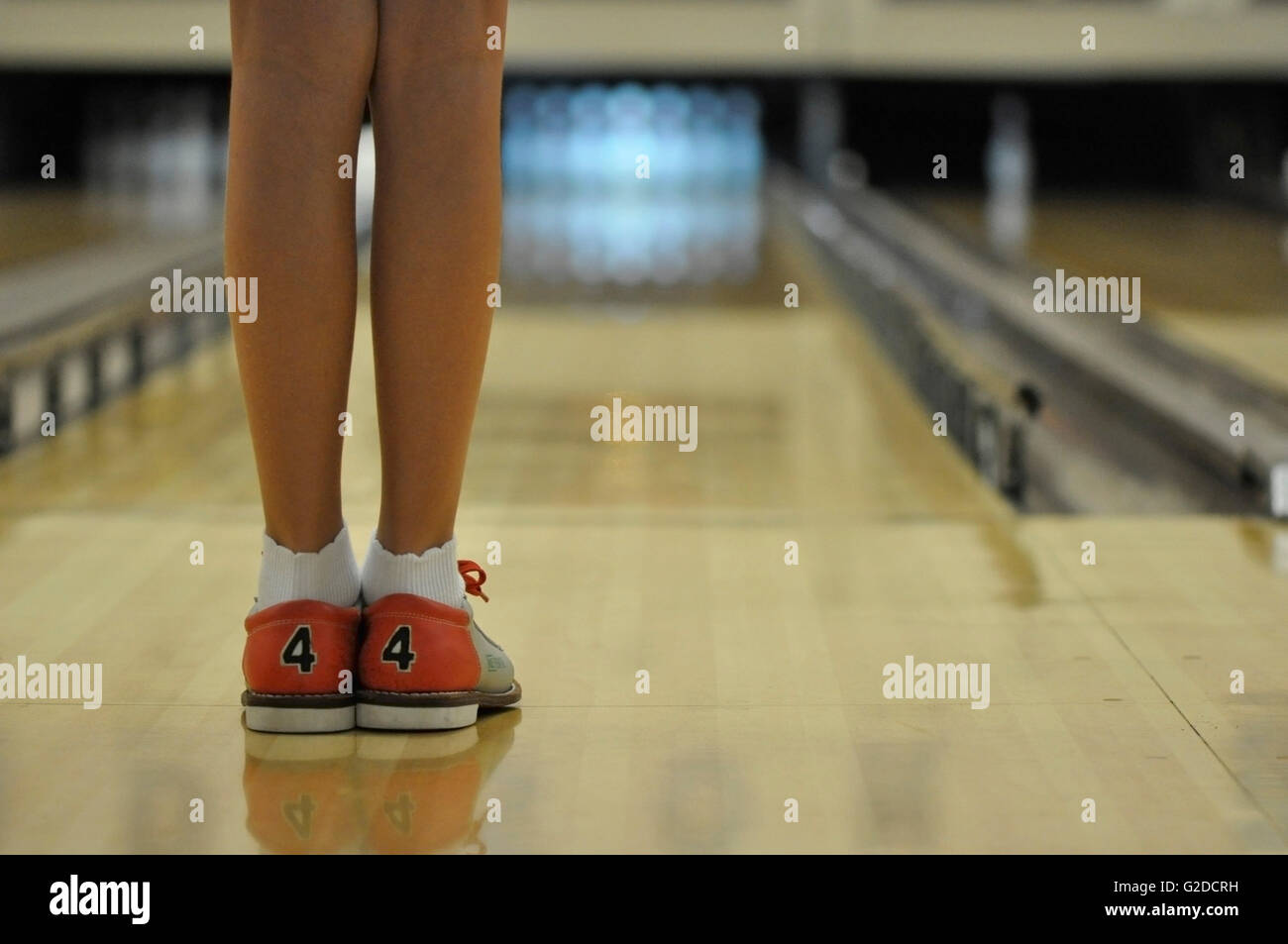 Young Girl Bowling, View of Legs and Feet, Rear View Stock Photo - Alamy