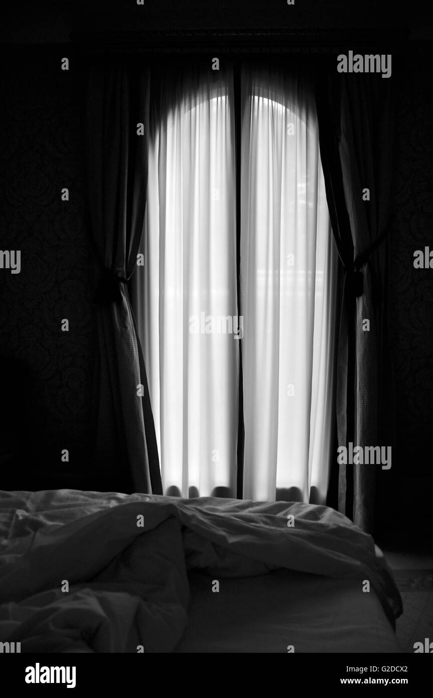 Sunlight Streaming Through Sheer Curtains of Hotel Room with Unmade Bed ...