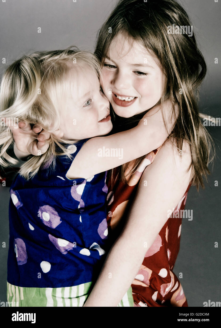 Two Young Sisters Hugging Stock Photo - Alamy
