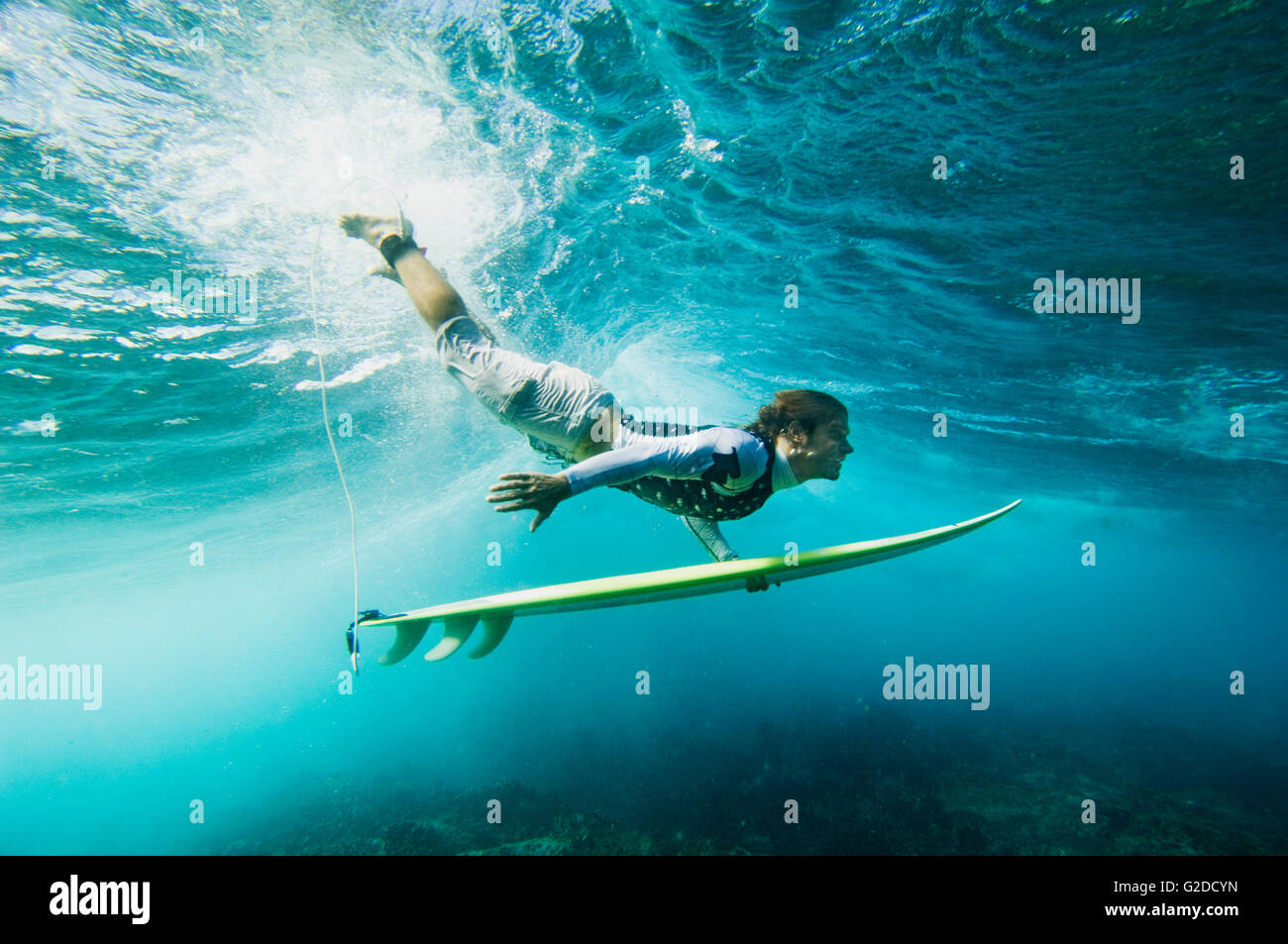 Surfer and Surboard Diving Under Wave Stock Photo - Alamy