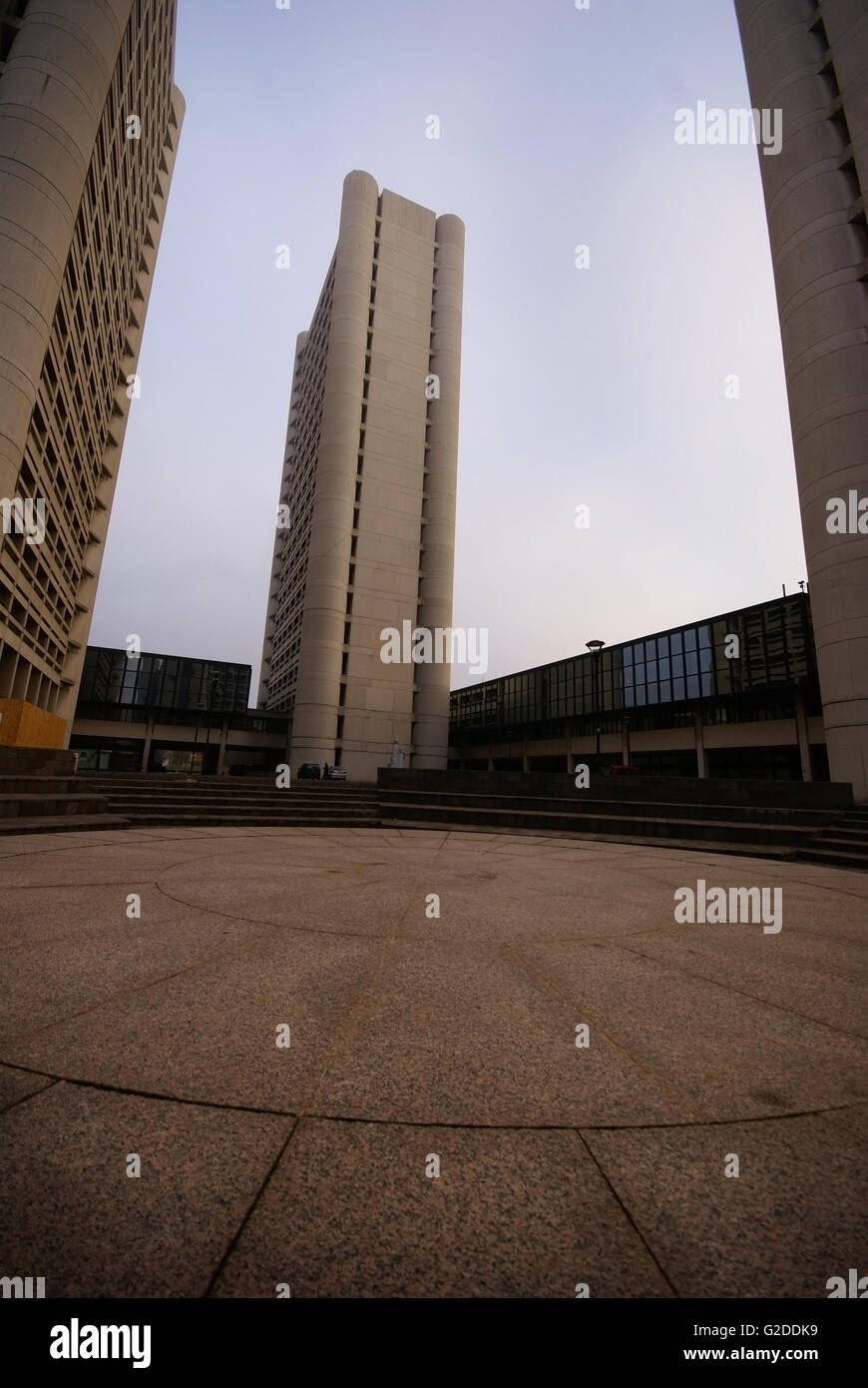 Ground level granite square with modern concrete and glass high-rises ...
