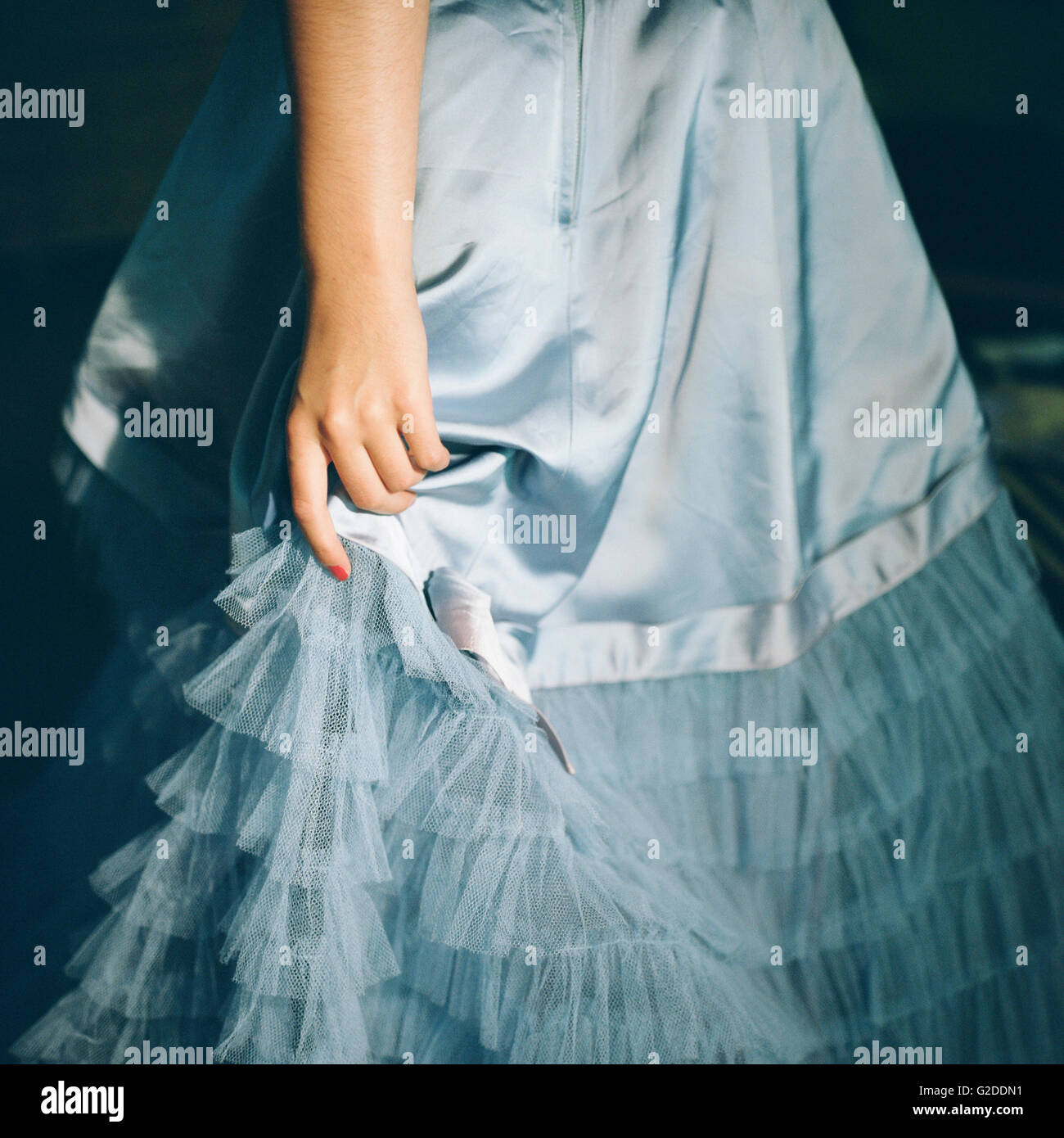 Hand of Teenage Girl Holding Blue Gown Stock Photo - Alamy
