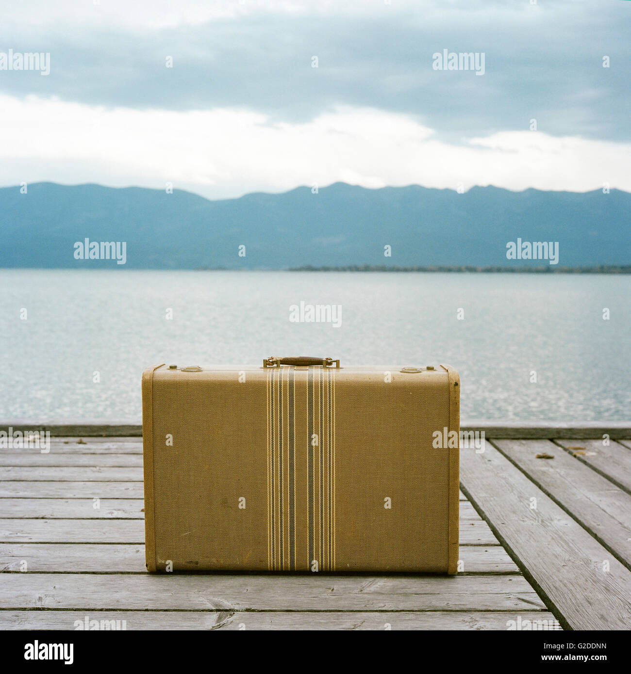 Suitcase on Dock with Lake in Background Stock Photo - Alamy