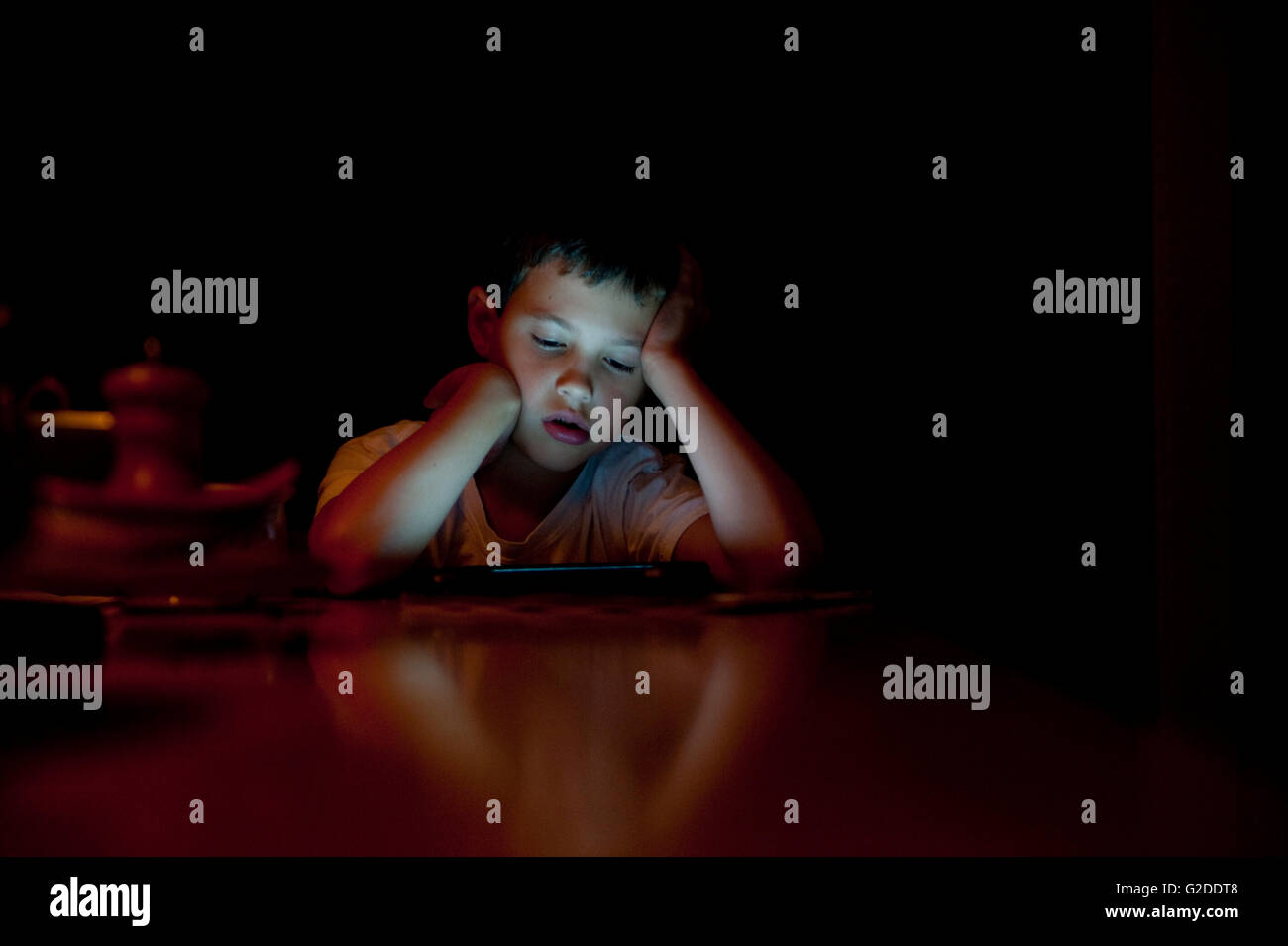 Boy Reading Computer at Night Stock Photo - Alamy
