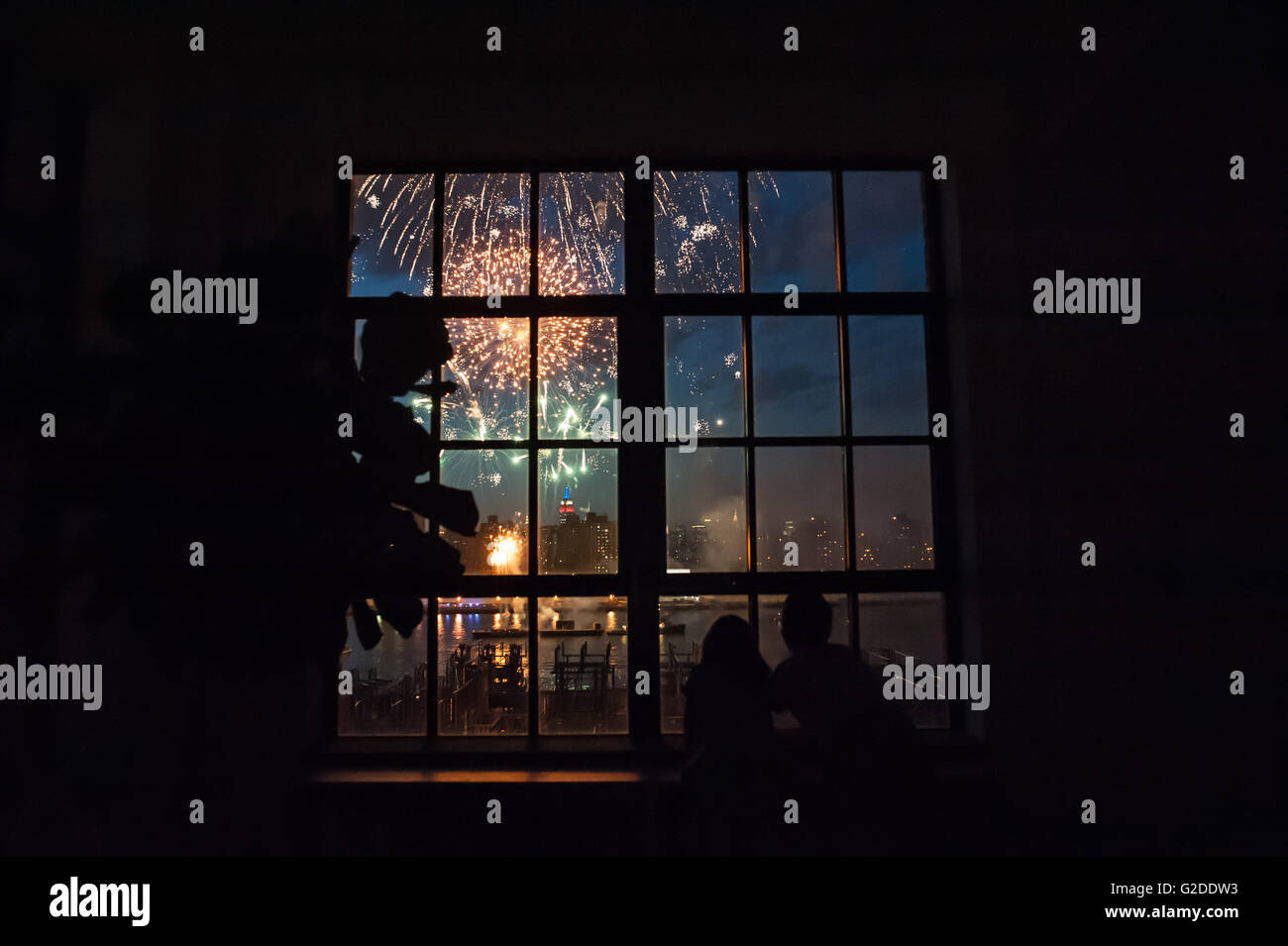Silhouhette of Couple Watching Fireworks Through Window with Empire ...