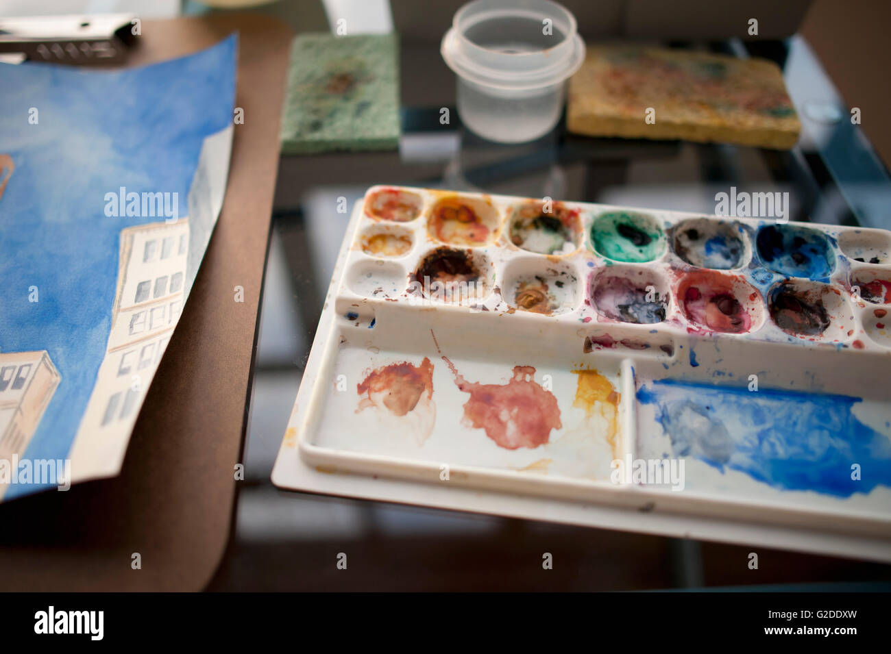 Messy Watercolor Palette Next to Watercolor Painting on Artist's Desk ...