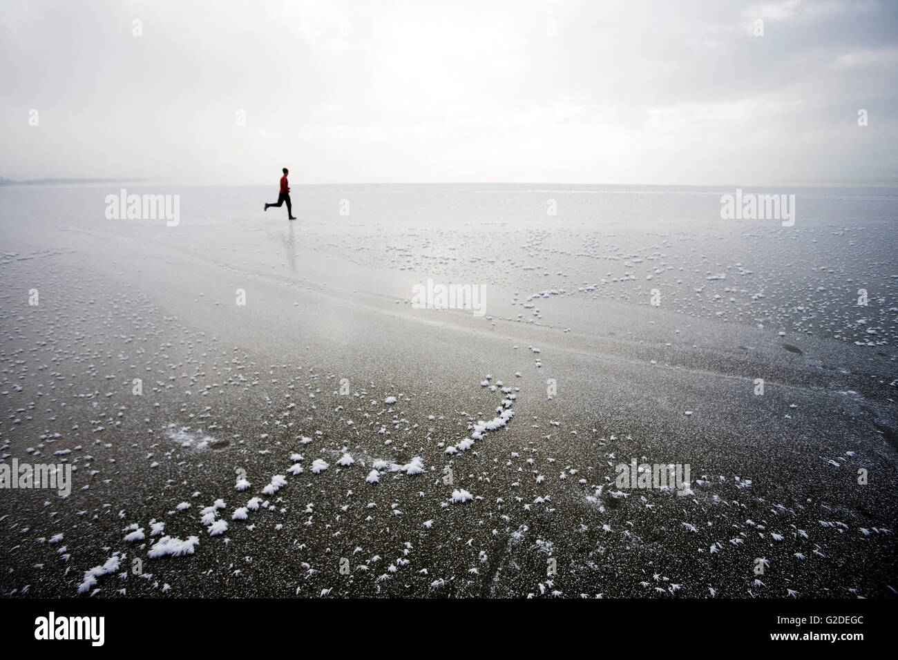 Profile of Man Running Across Frozen Stock Photo - Alamy