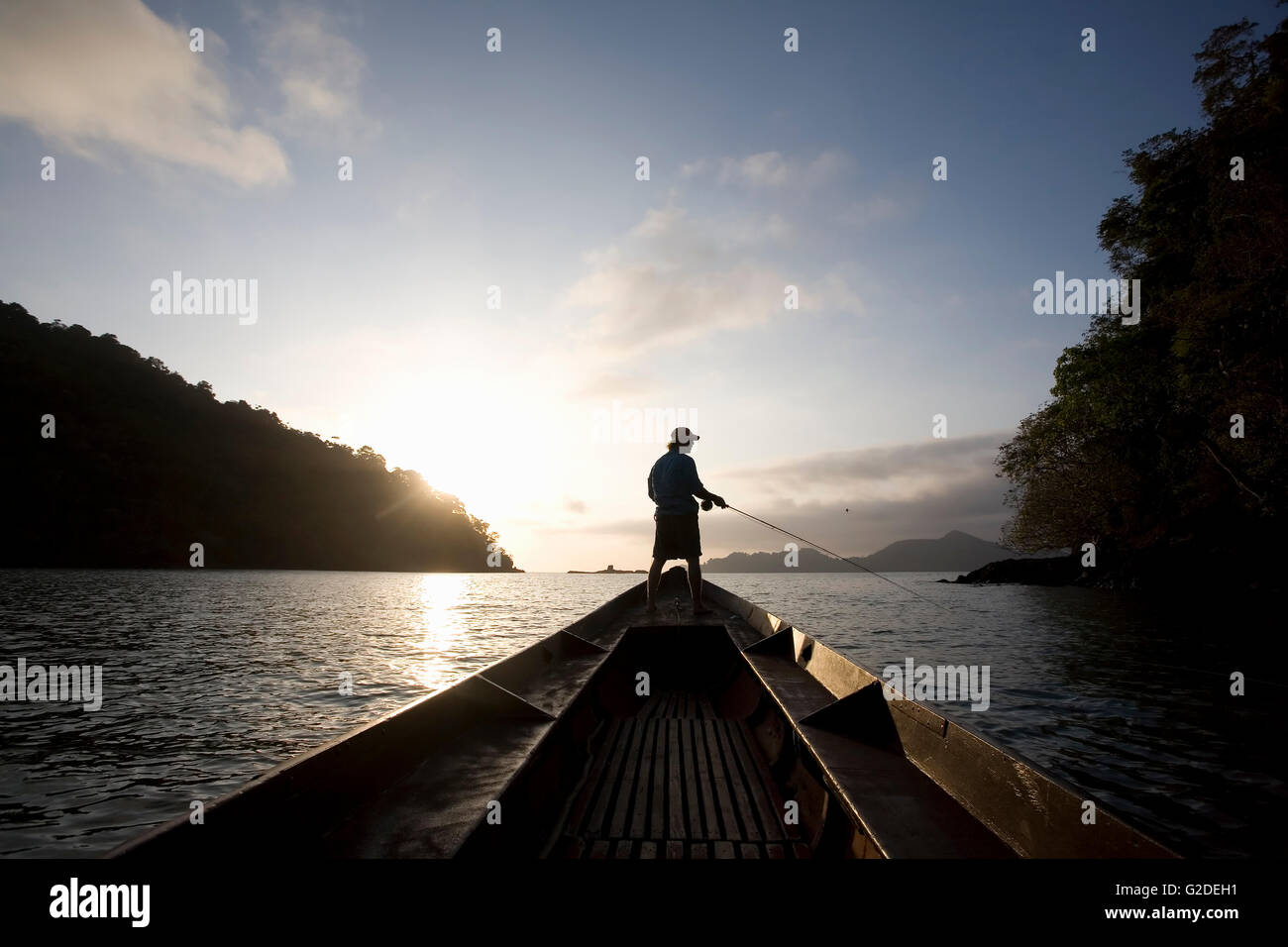 Silhouette of Man Fishing on Boat at Sunset Stock Photo - Alamy