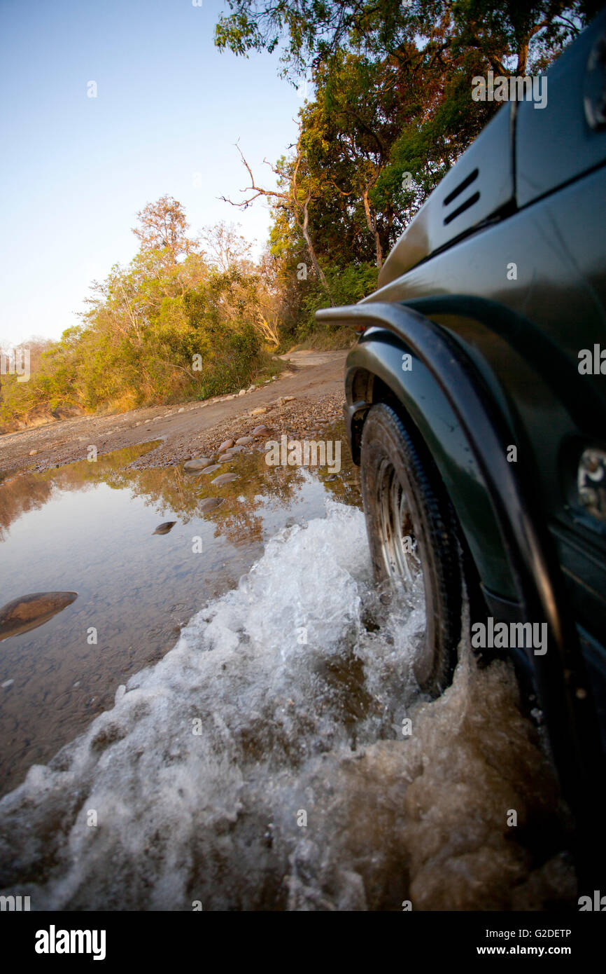Jeep Driving Through Puddle in Dirt Road, India Stock Photo - Alamy