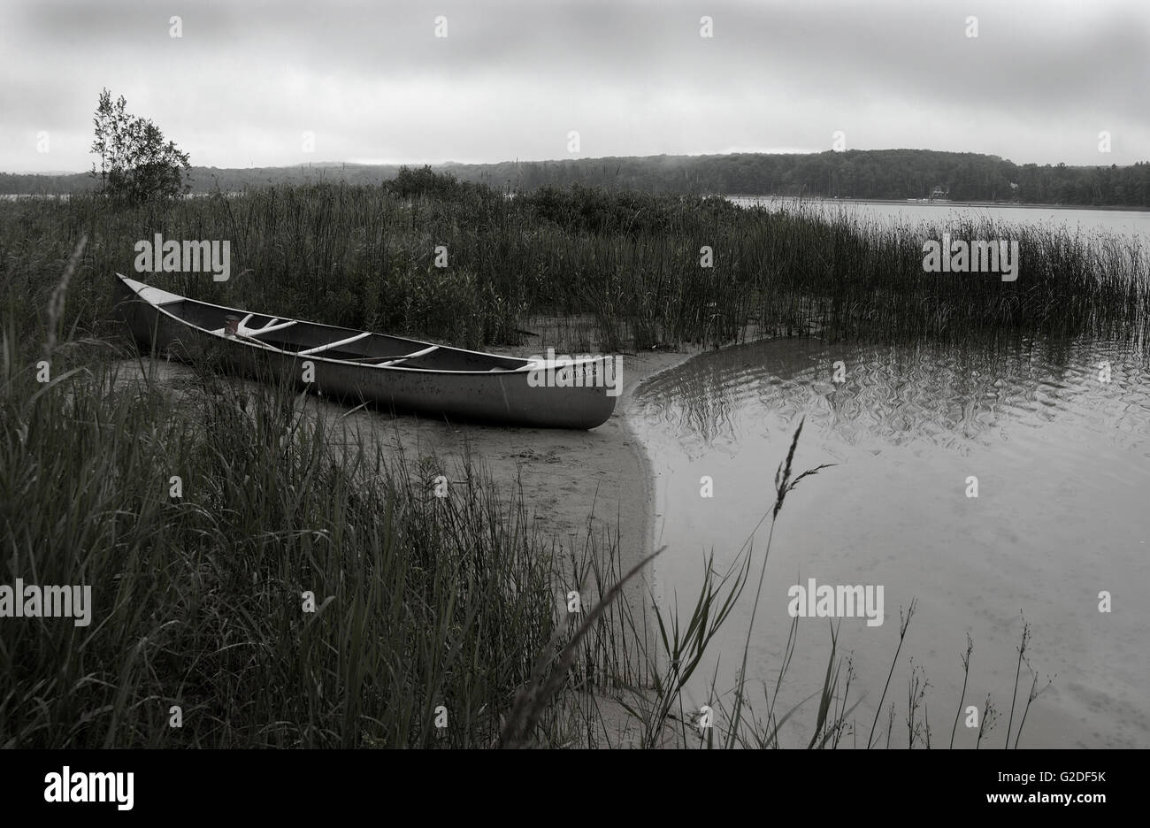 Beached Canoe on Small Lake Stock Photo - Alamy