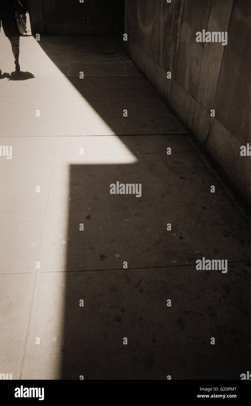 Woman Walking Along Building Shadow, New York City, USA Stock Photo - Alamy