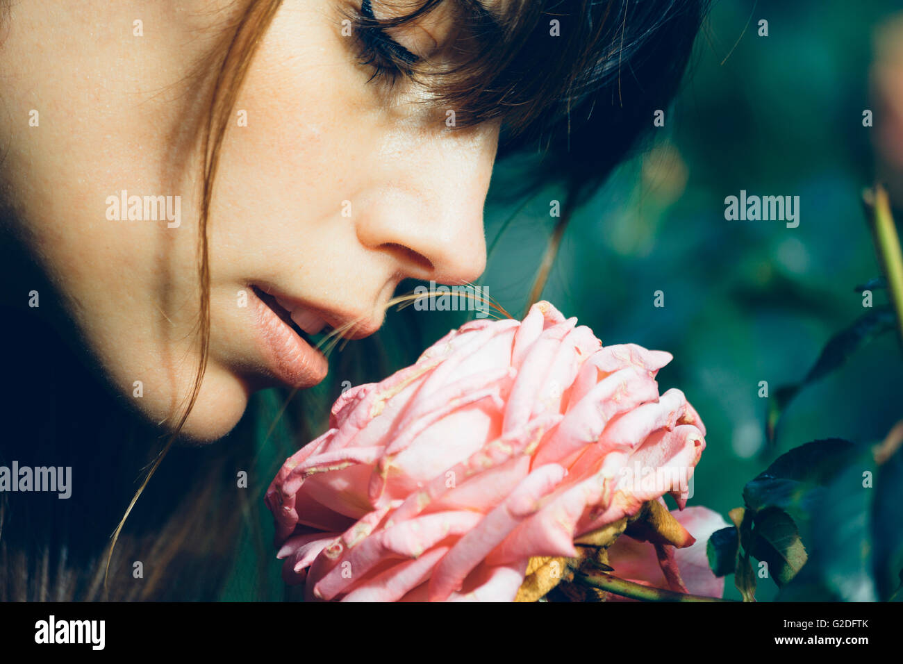 Woman smelling rose petals hi-res stock photography and images - Alamy