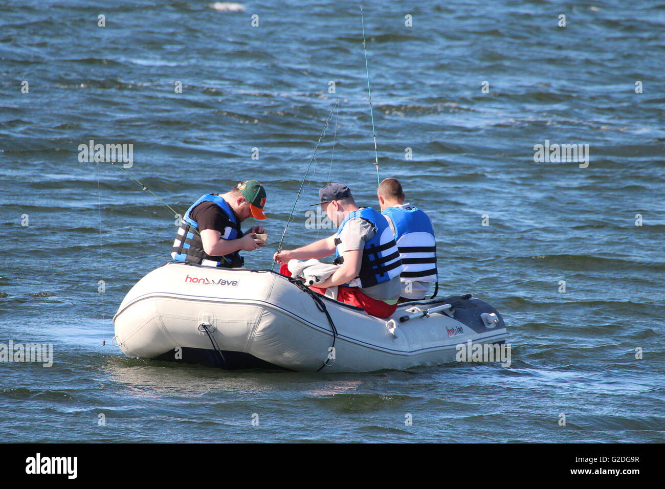 Three fishermen do a spot of sea angling on the Firth of Clyde, from a ...