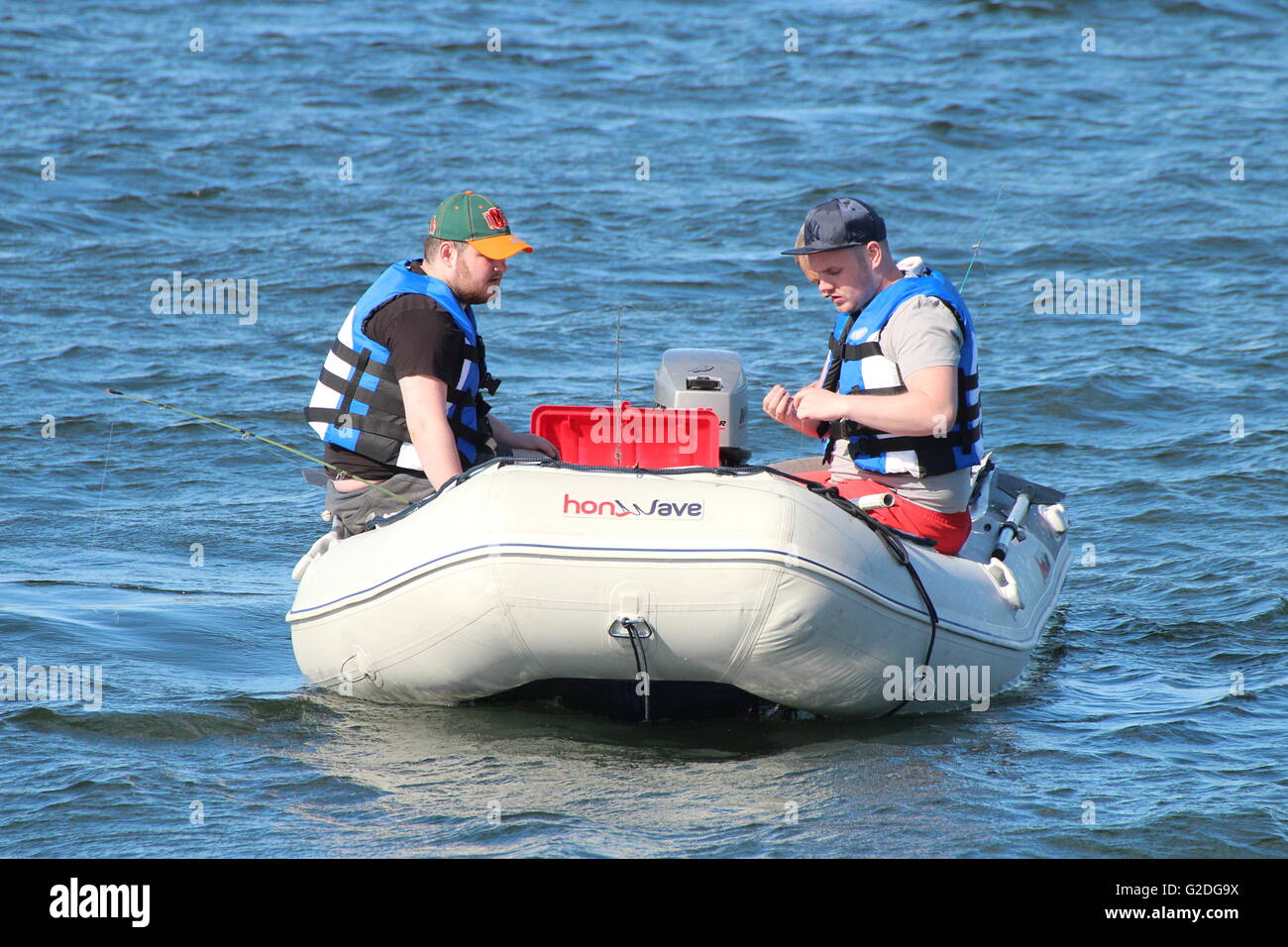 Three fishermen do a spot of sea angling on the Firth of Clyde, from a ...