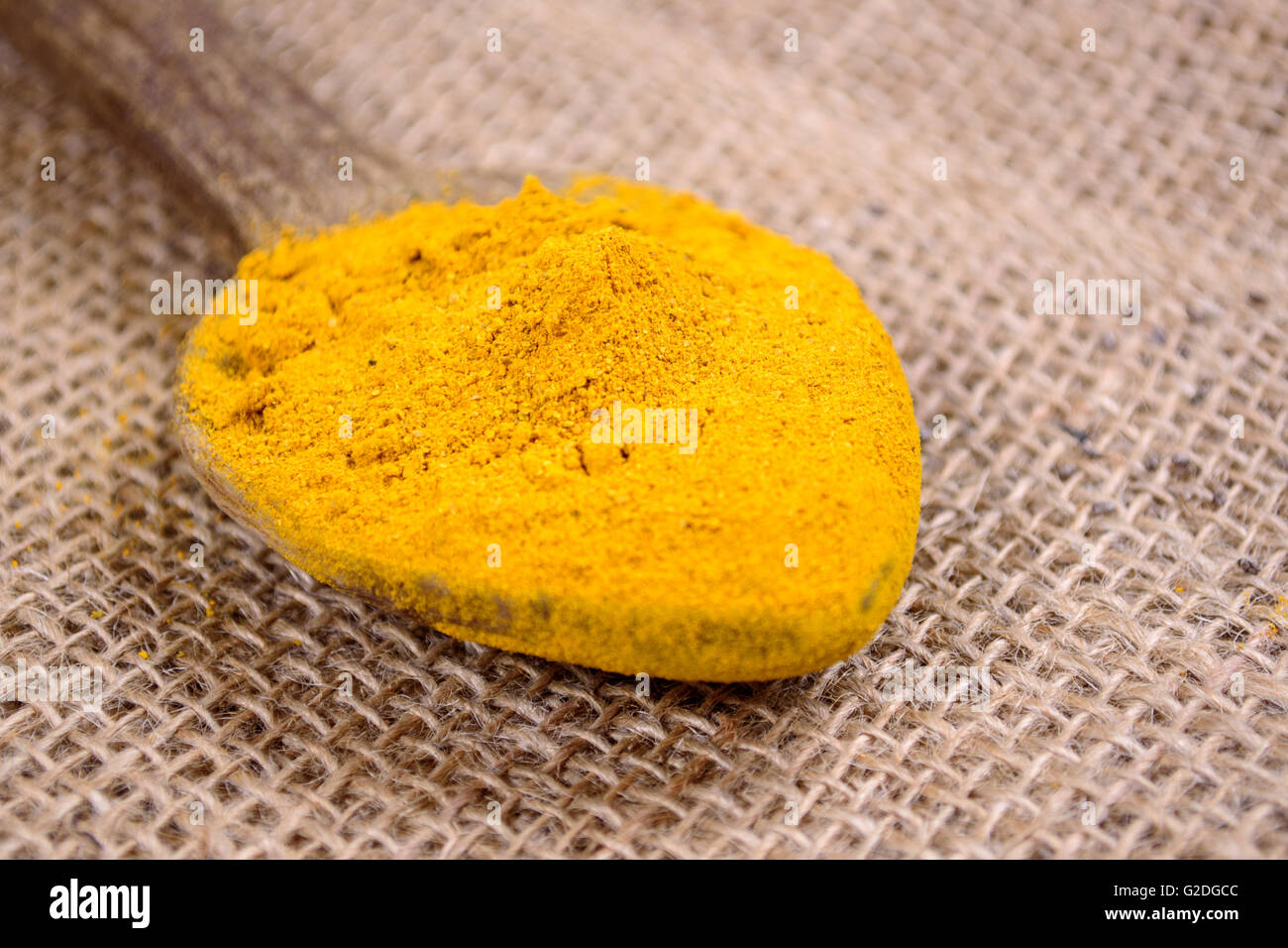 Turmeric powder on wooden spoon. Curcuma Stock Photo - Alamy