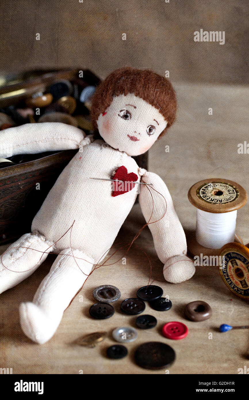 Old Rag Doll on table with antique sewing utensils Stock Photo - Alamy