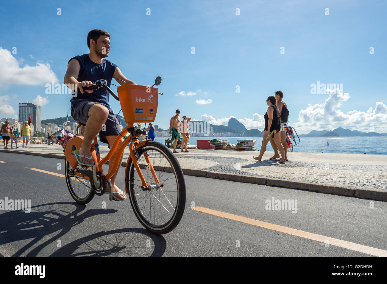 RIO DE JANEIRO - MARCH 20, 2016: Brazilian rides an orange bike-share ...