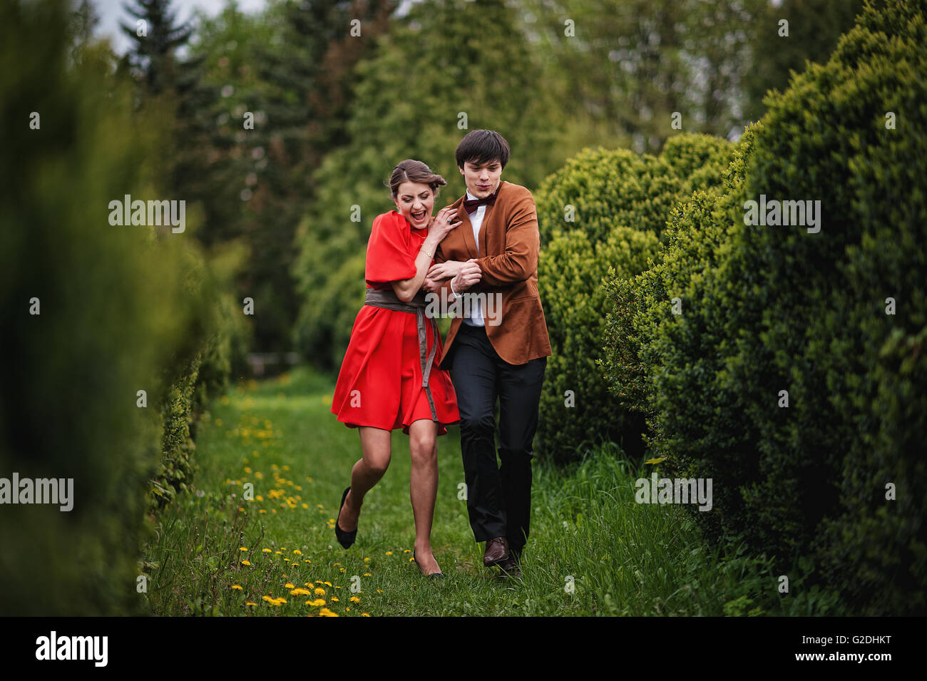 Happy and smiled couple running in love at park garden. Stylish man at ...