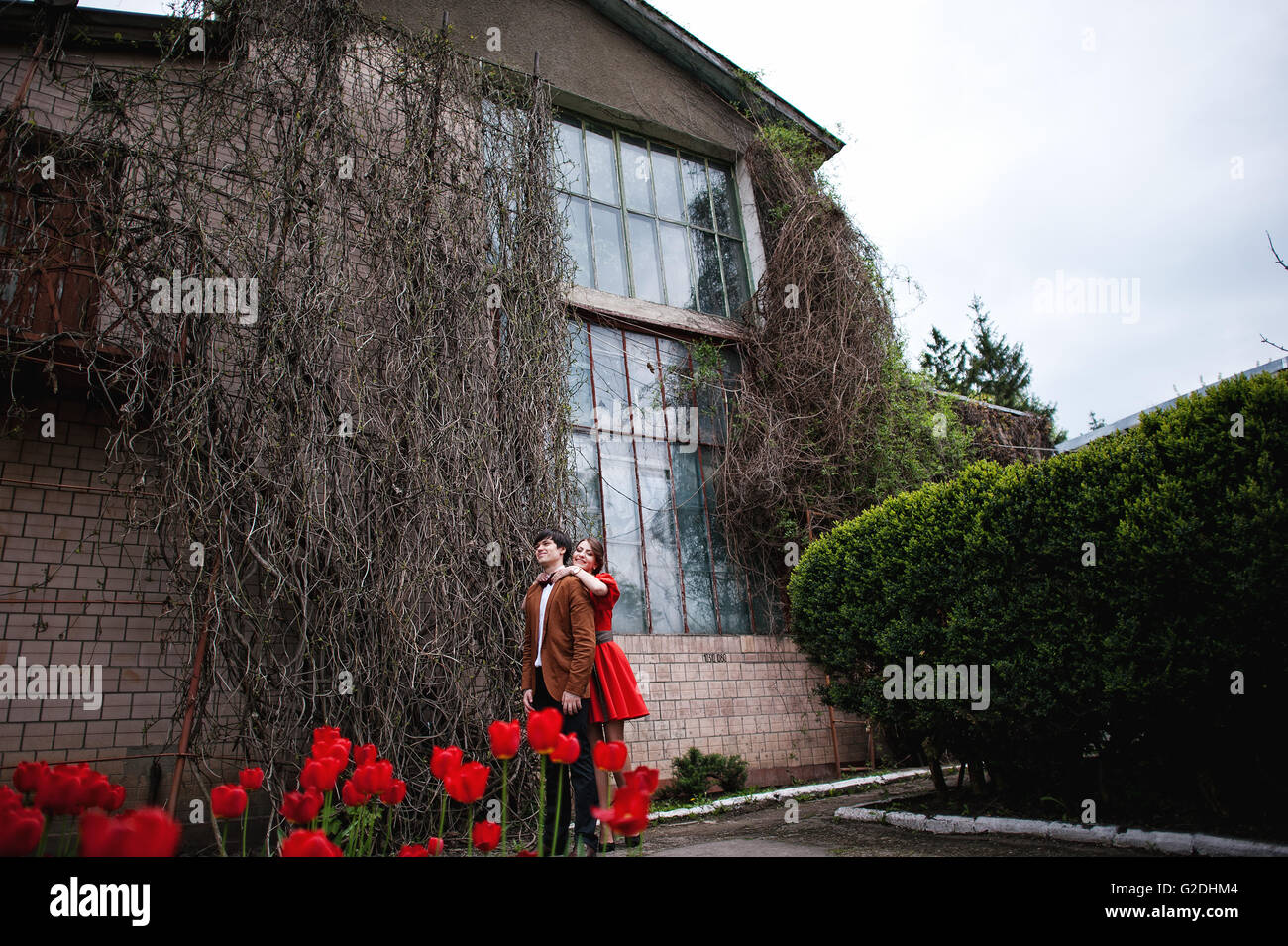 Couple hugging in love background old mansion house with large window ...
