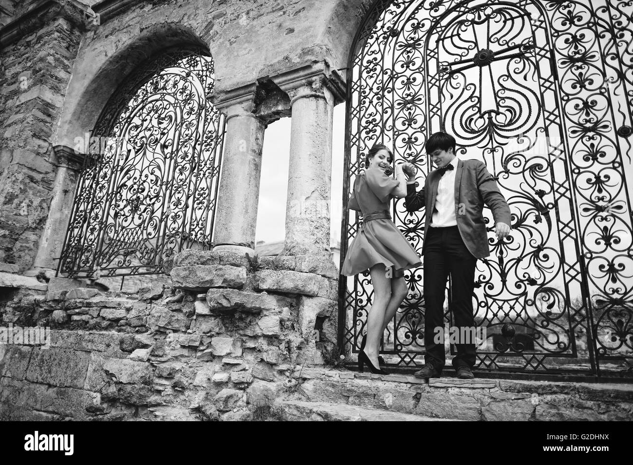 Couple hugging in love background old gates of castle. Stylish man at ...