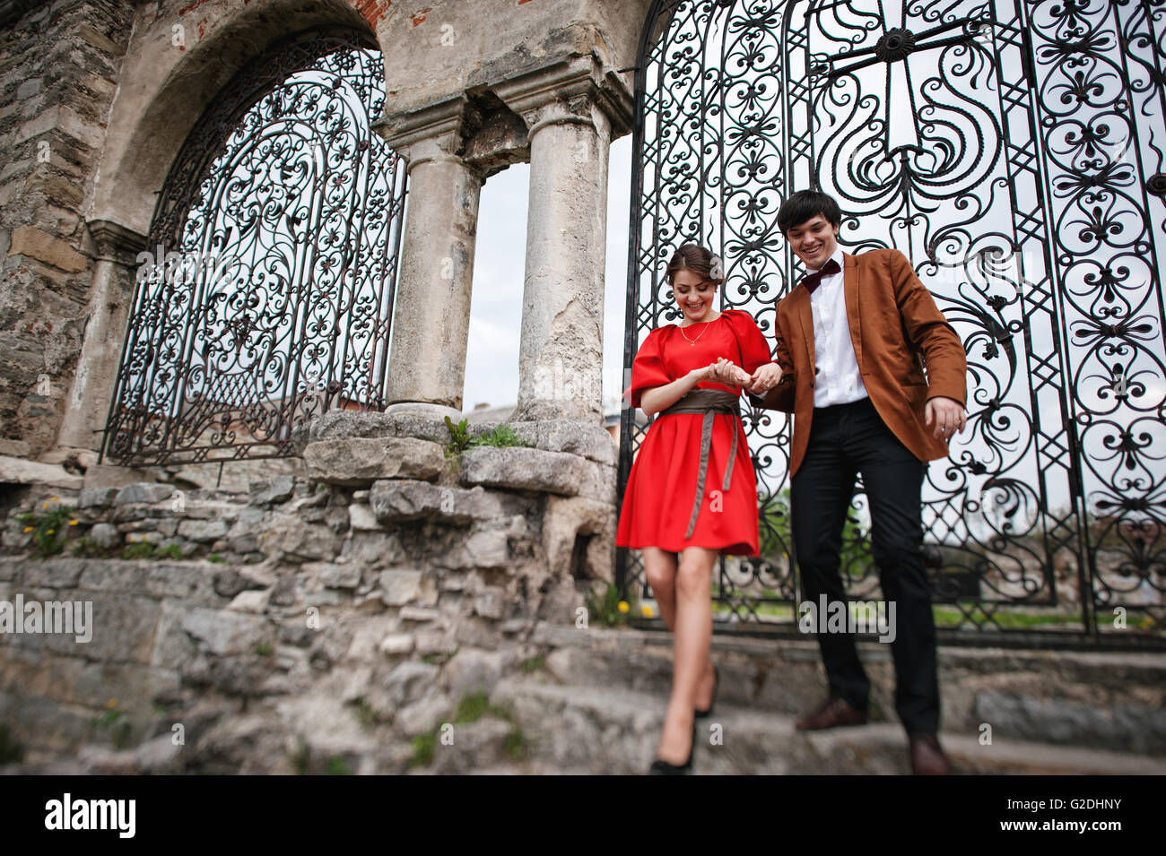 Couple hugging in love background old gates of castle. Stylish man at ...