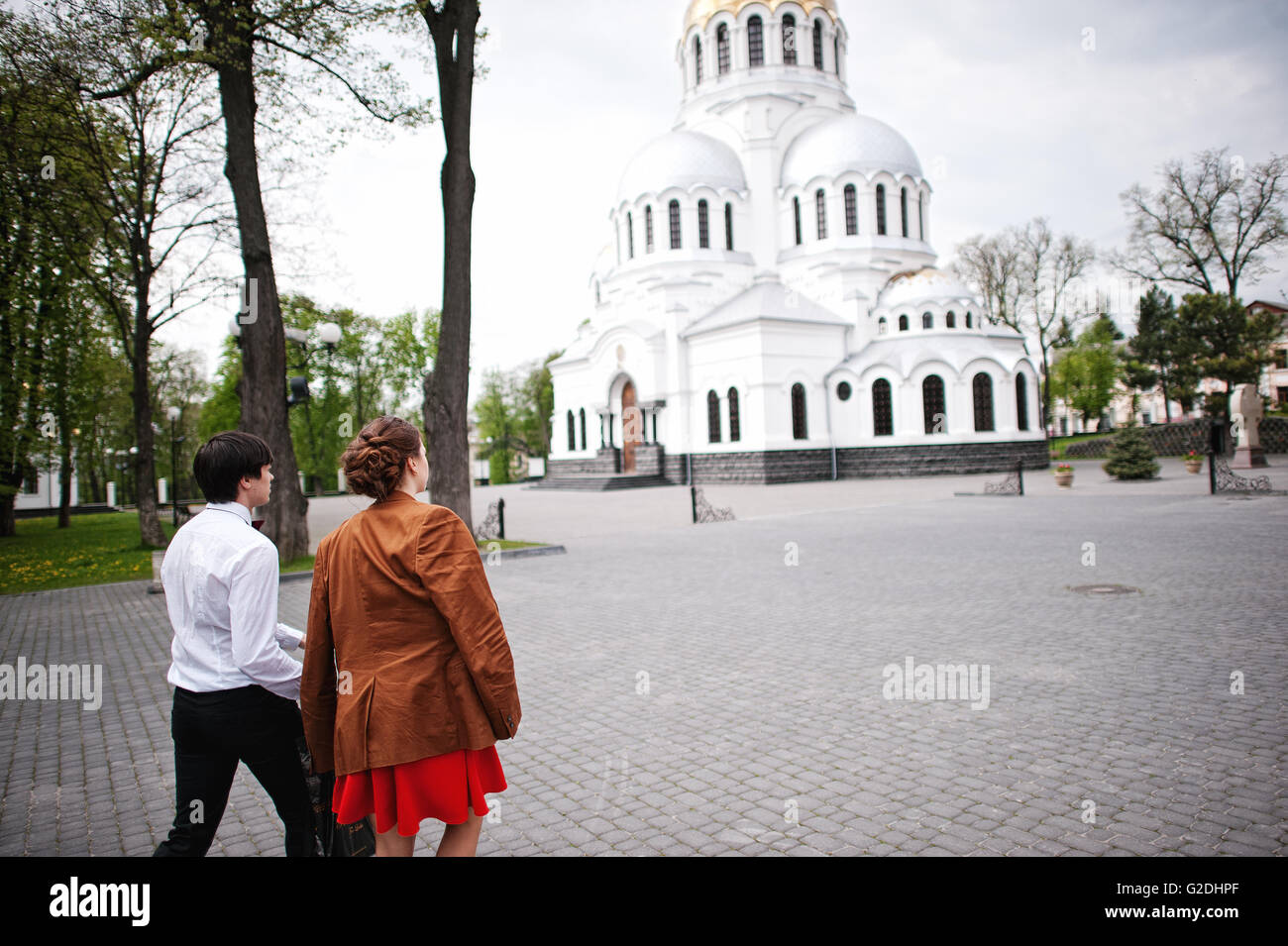 Couple hugging in love background church. Stylish man at velvet jacket ...