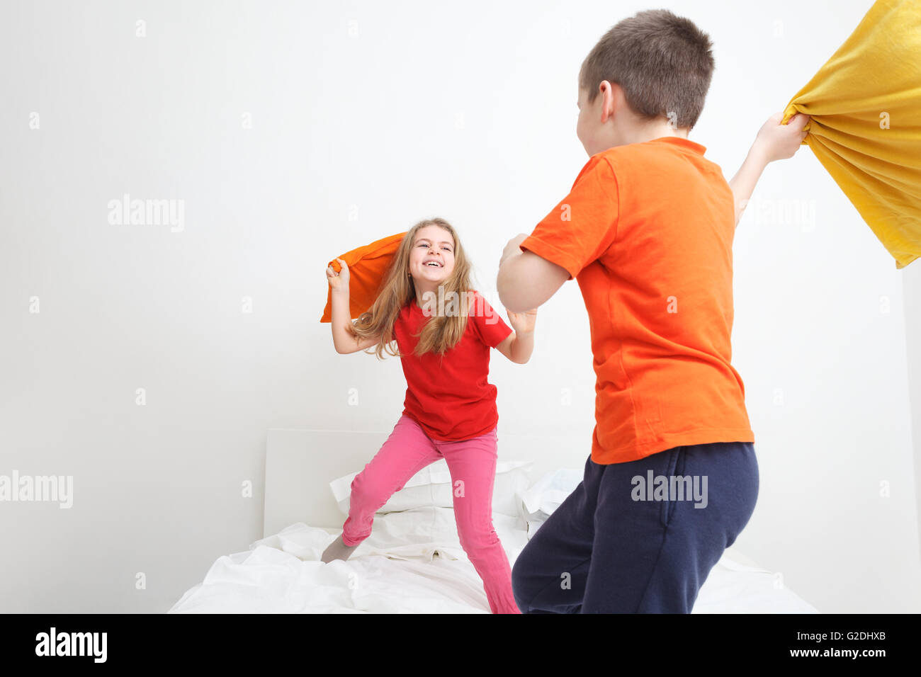 kids having a pillow fight in bed Stock Photo - Alamy