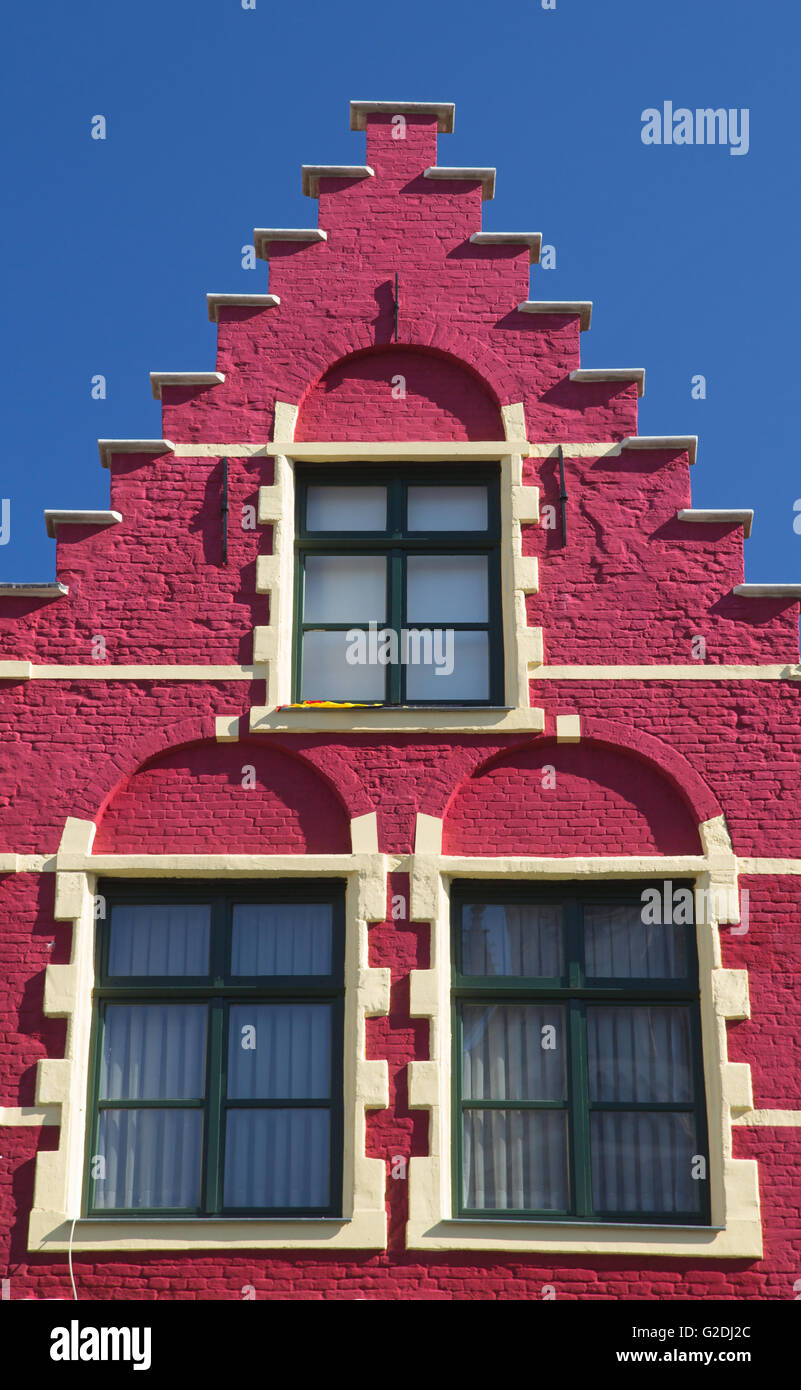 Red gable roof of the historic house (Bruges, Belgium). Front view ...