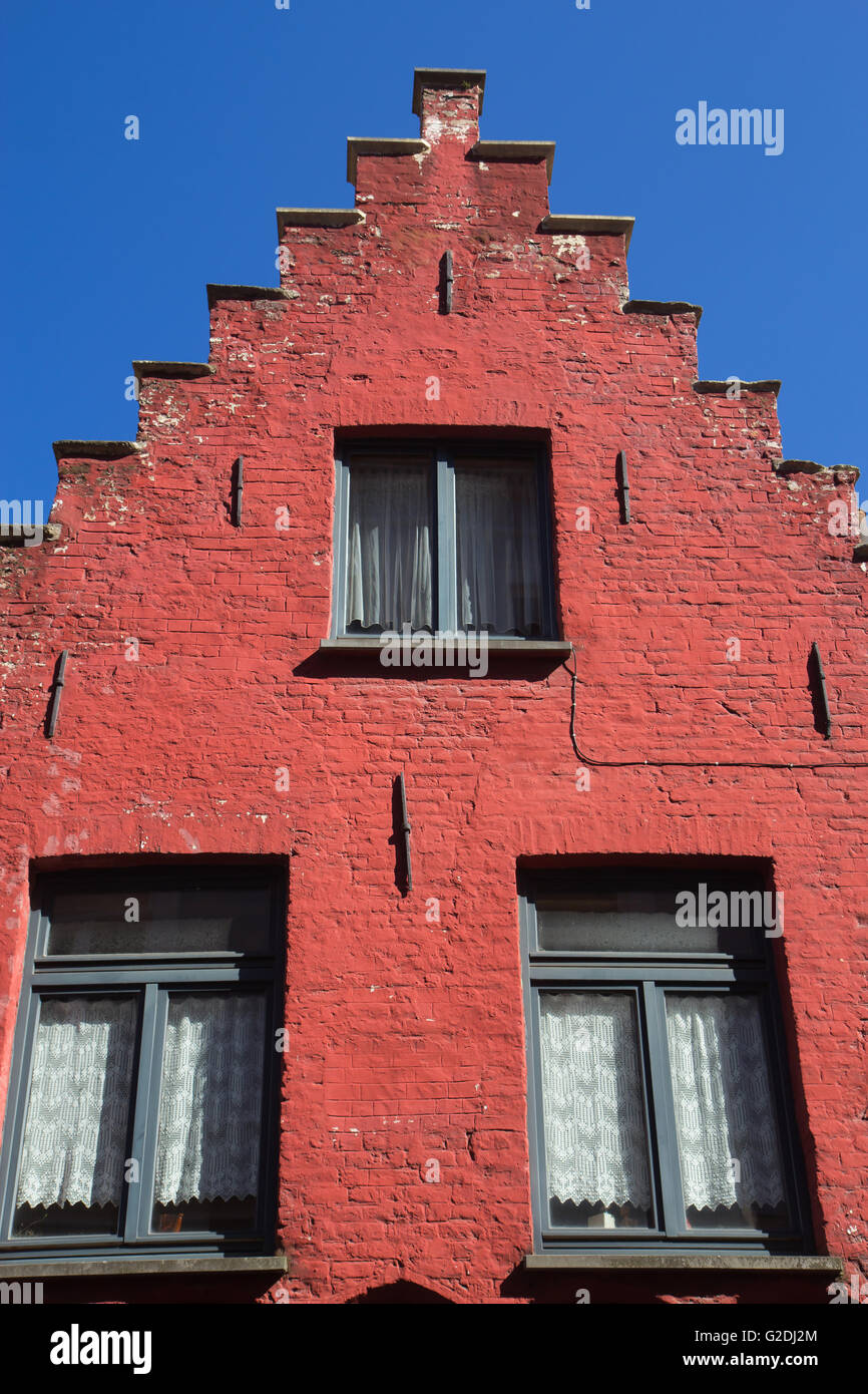Red gable roof of the historic house (Bruges, Belgium). Front view ...