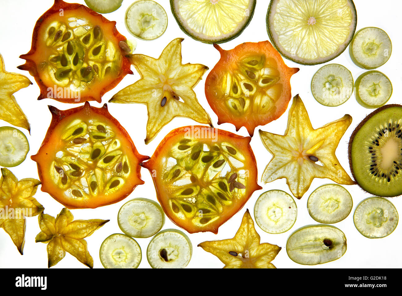Variety of fresh exotic fruits cut to slices on white background Stock ...