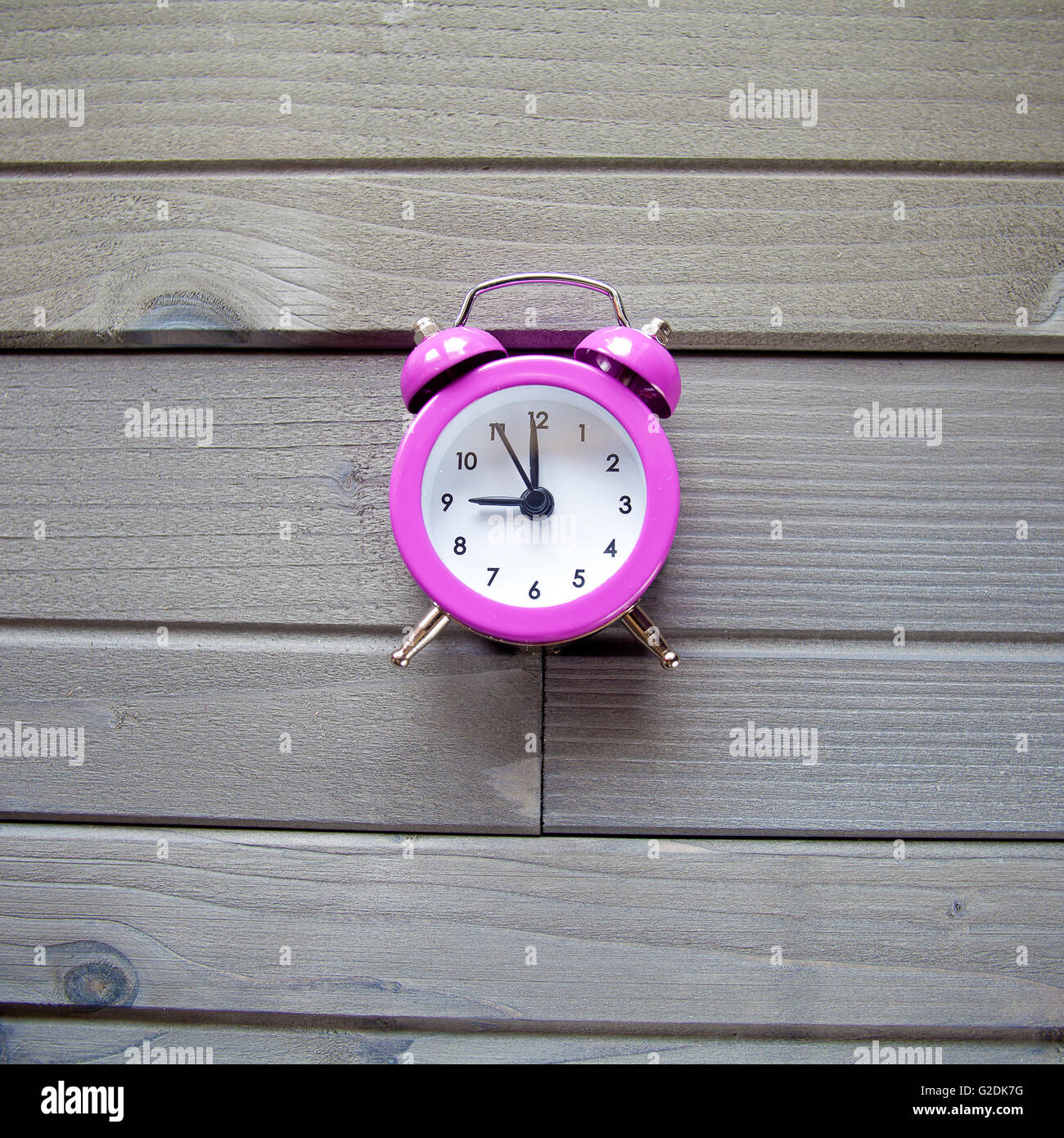 Purple Clock isolated on wood Stock Photo - Alamy