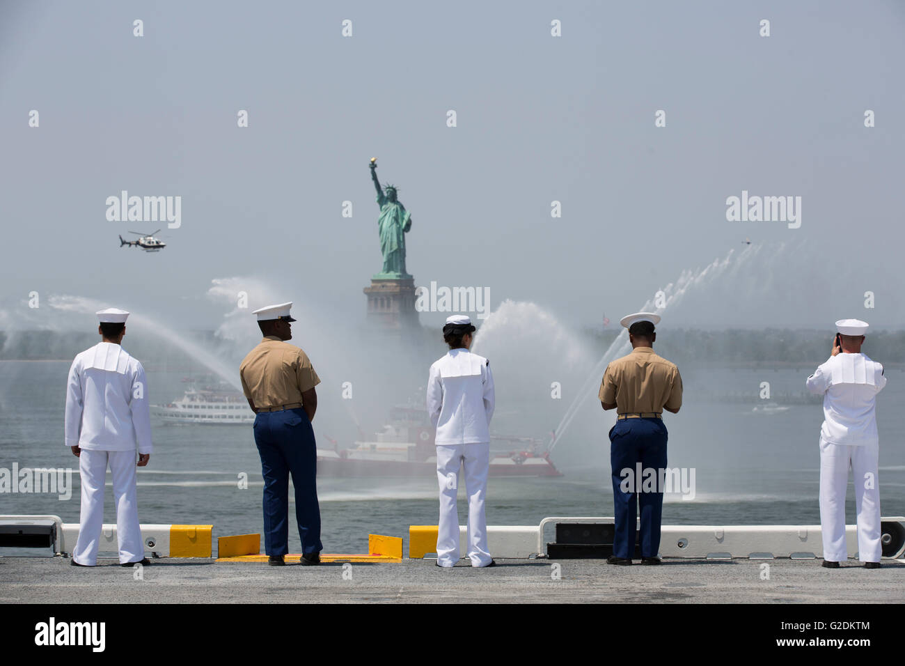US Sailors and Marines aboard the amphibious assault ship USS Bataan ...