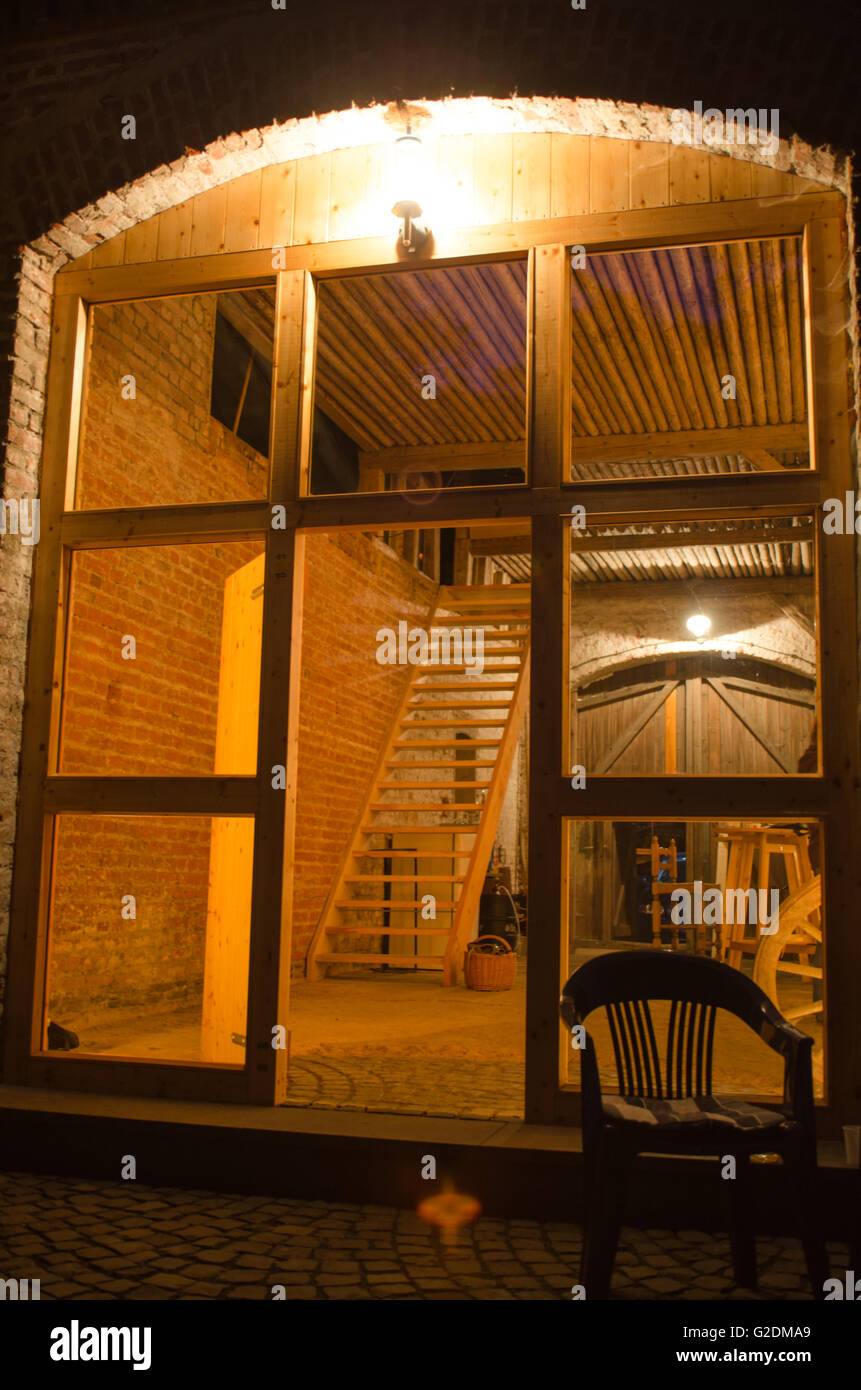 Looking into a lit barn through a glass front Stock Photo - Alamy