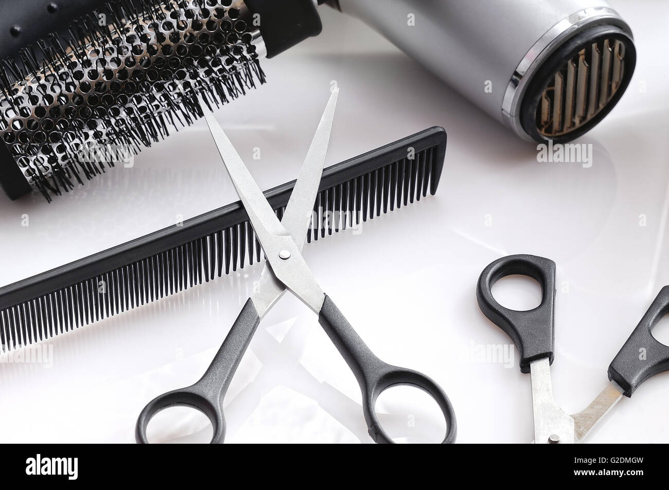 scissors and combs on white glass table top view Stock Photo - Alamy